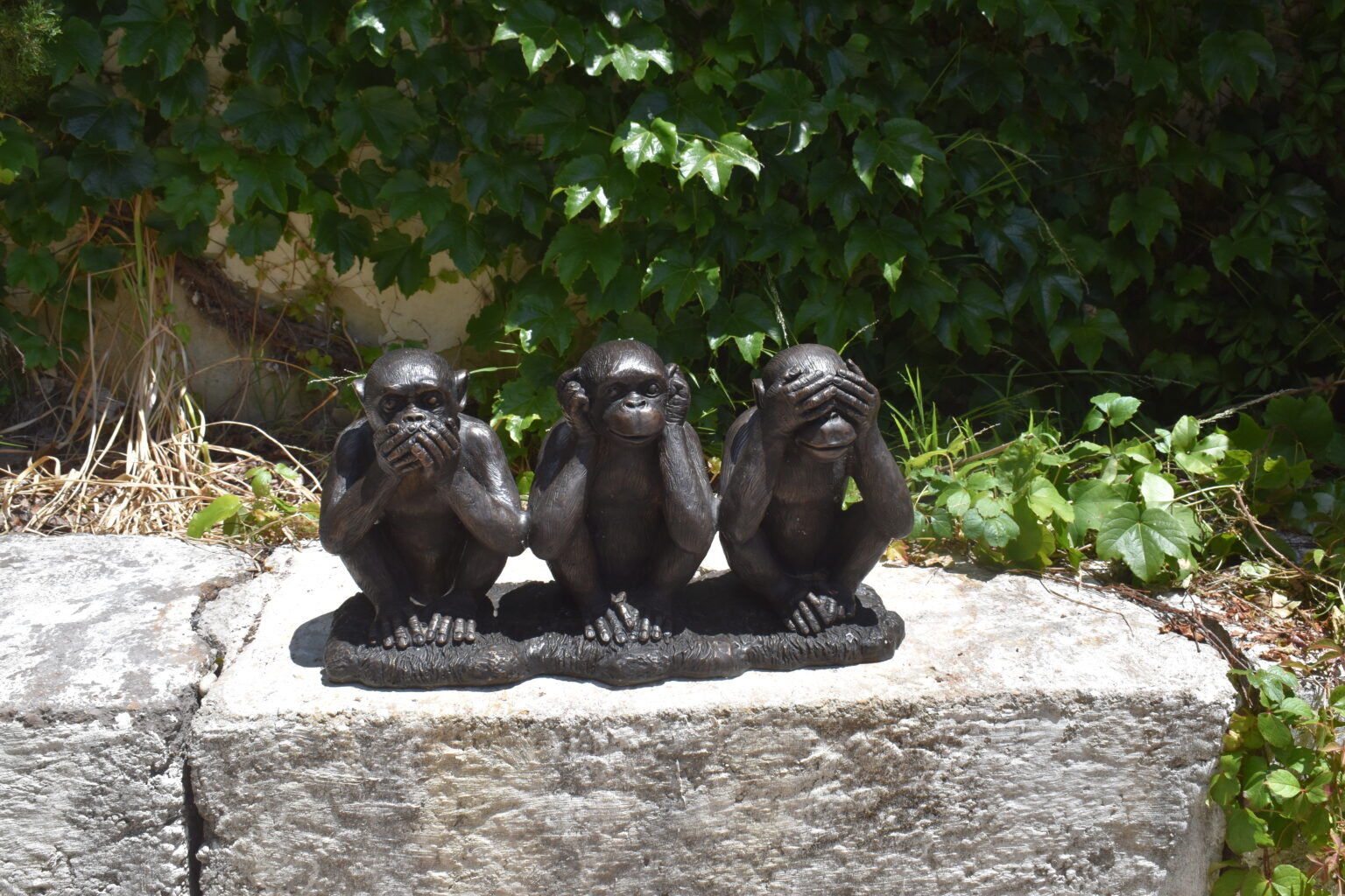 A bronze statue of 3 monkeys representing hear no evil, speak no evil ...